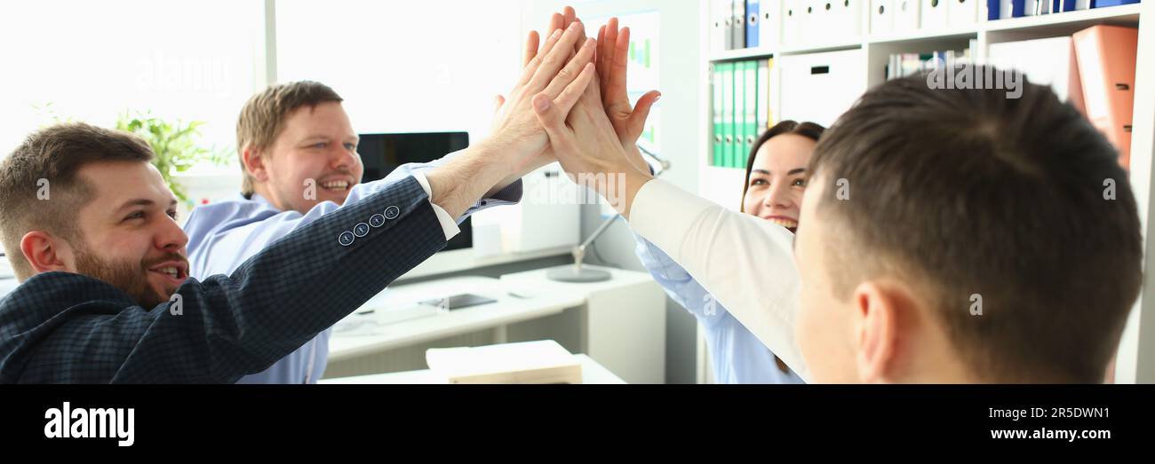 Team of business people at negotiating table successfully solves ...