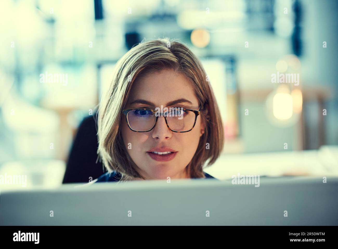 Maintaining a focused mindset. a young businesswoman working late in an ...