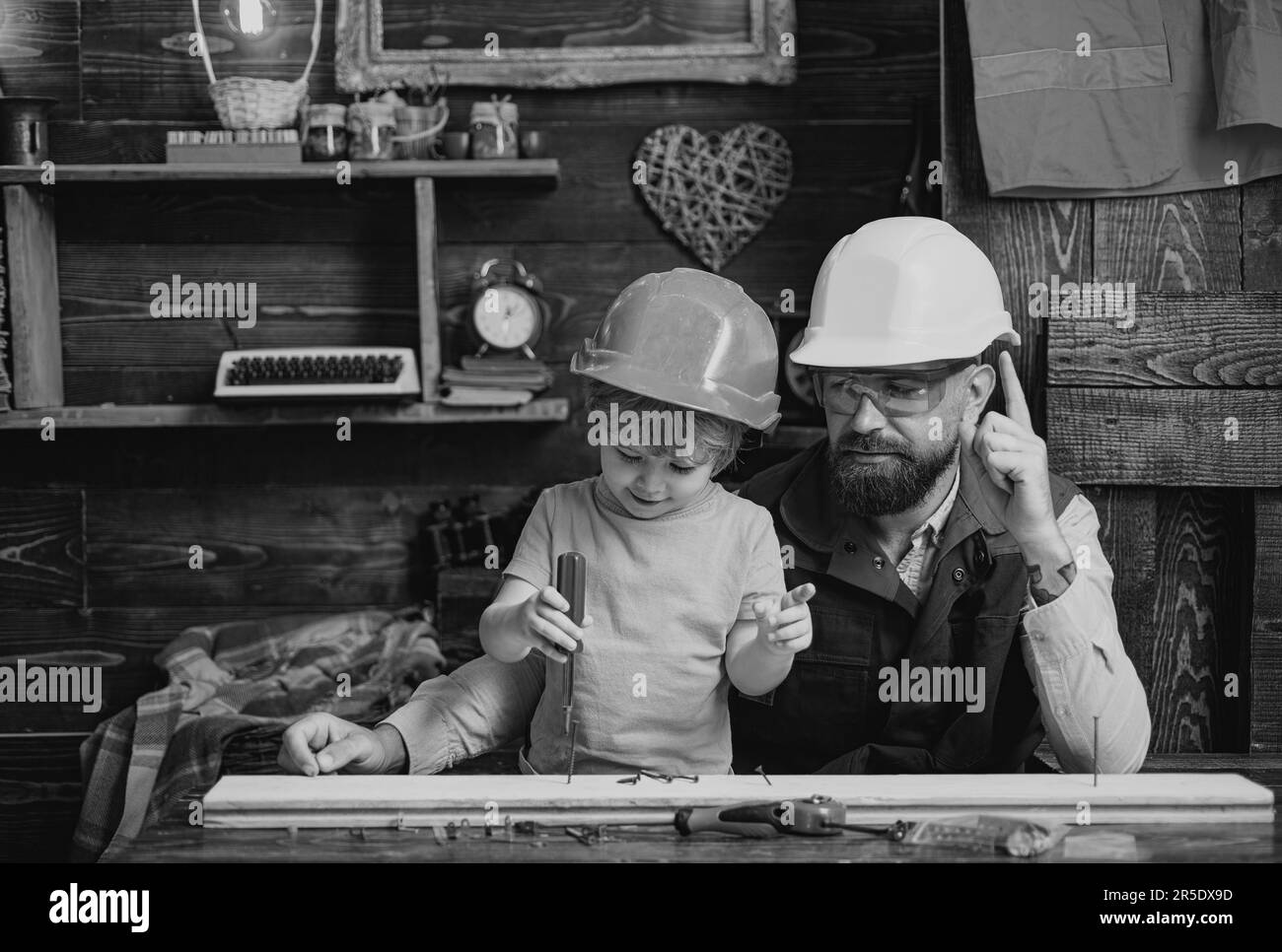 Father and his son working together in a wooden workshop Stock Photo ...