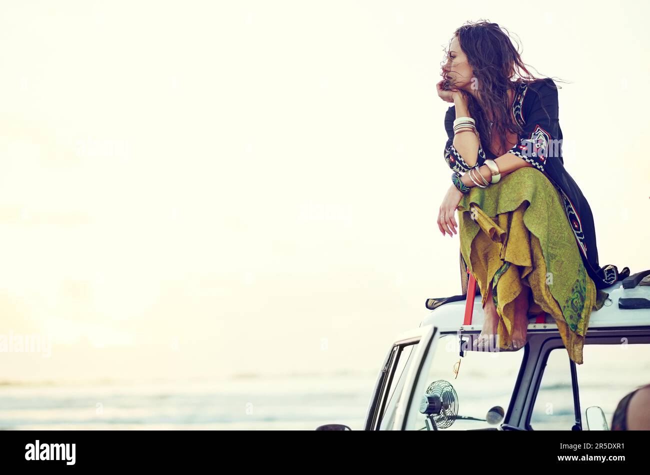 Getting a better view. a young woman stopping at the beach during a ...