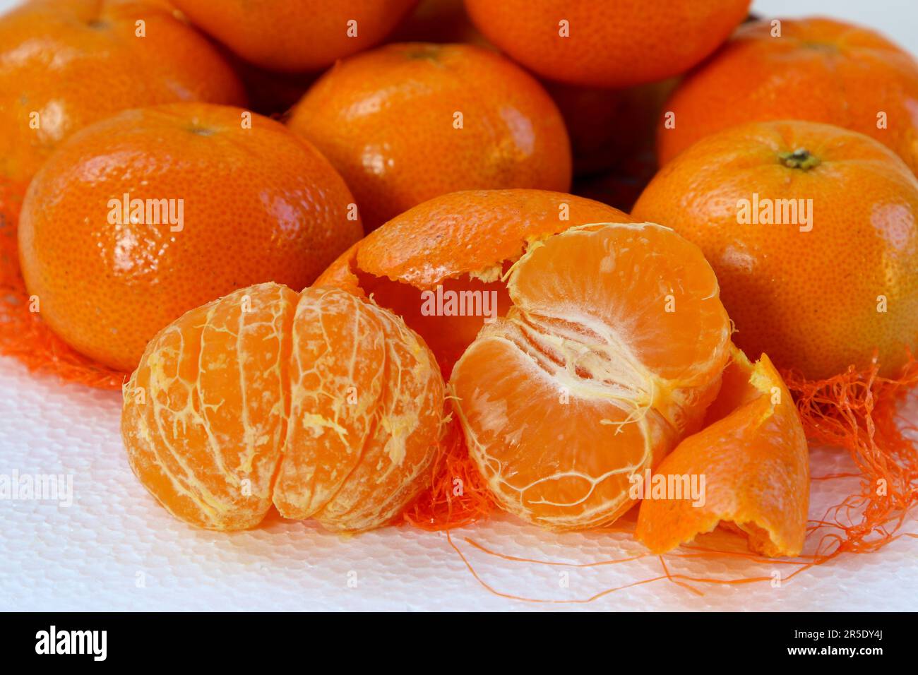 Fresh mandarins peeled and ready to eat Stock Photo - Alamy