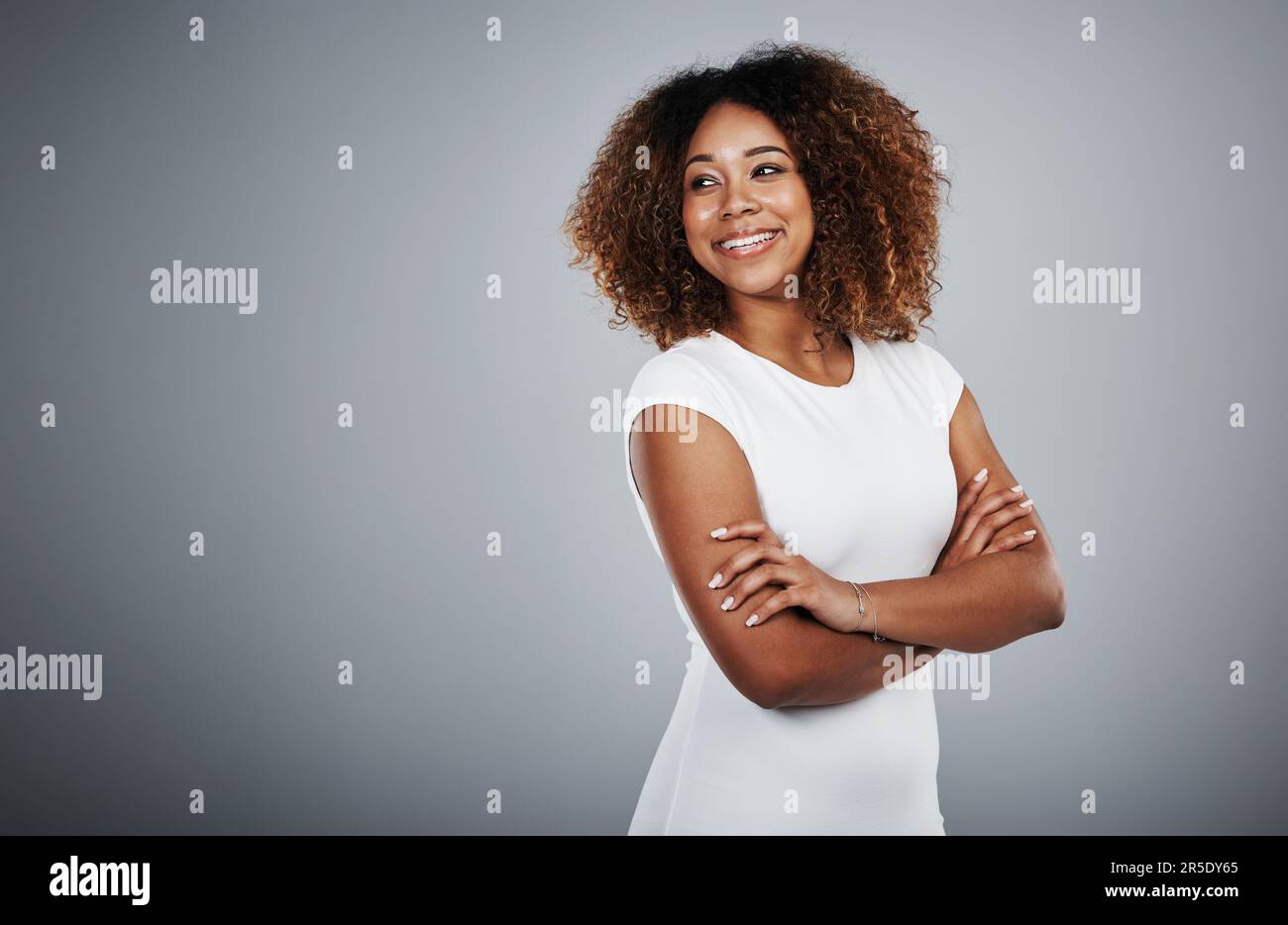 I look back and smile at how far Ive come. Studio shot of a young ...