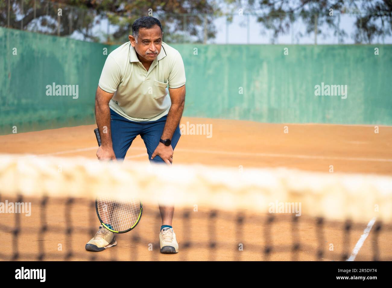 Indian tired exhausted senior tennis player breathing heavily after ...