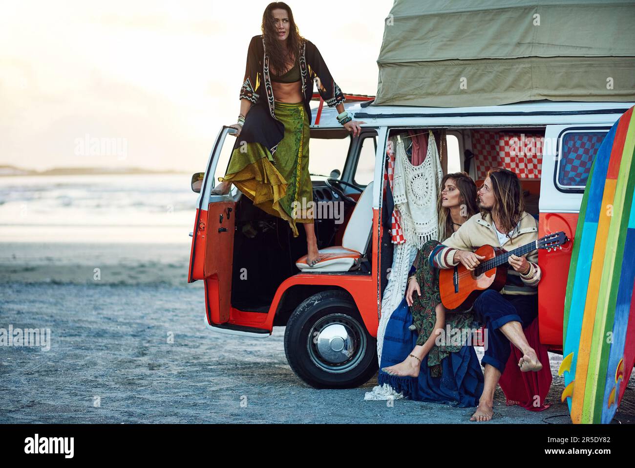 Roadtrip vibes. a group of young friends stopping at the beach during a ...