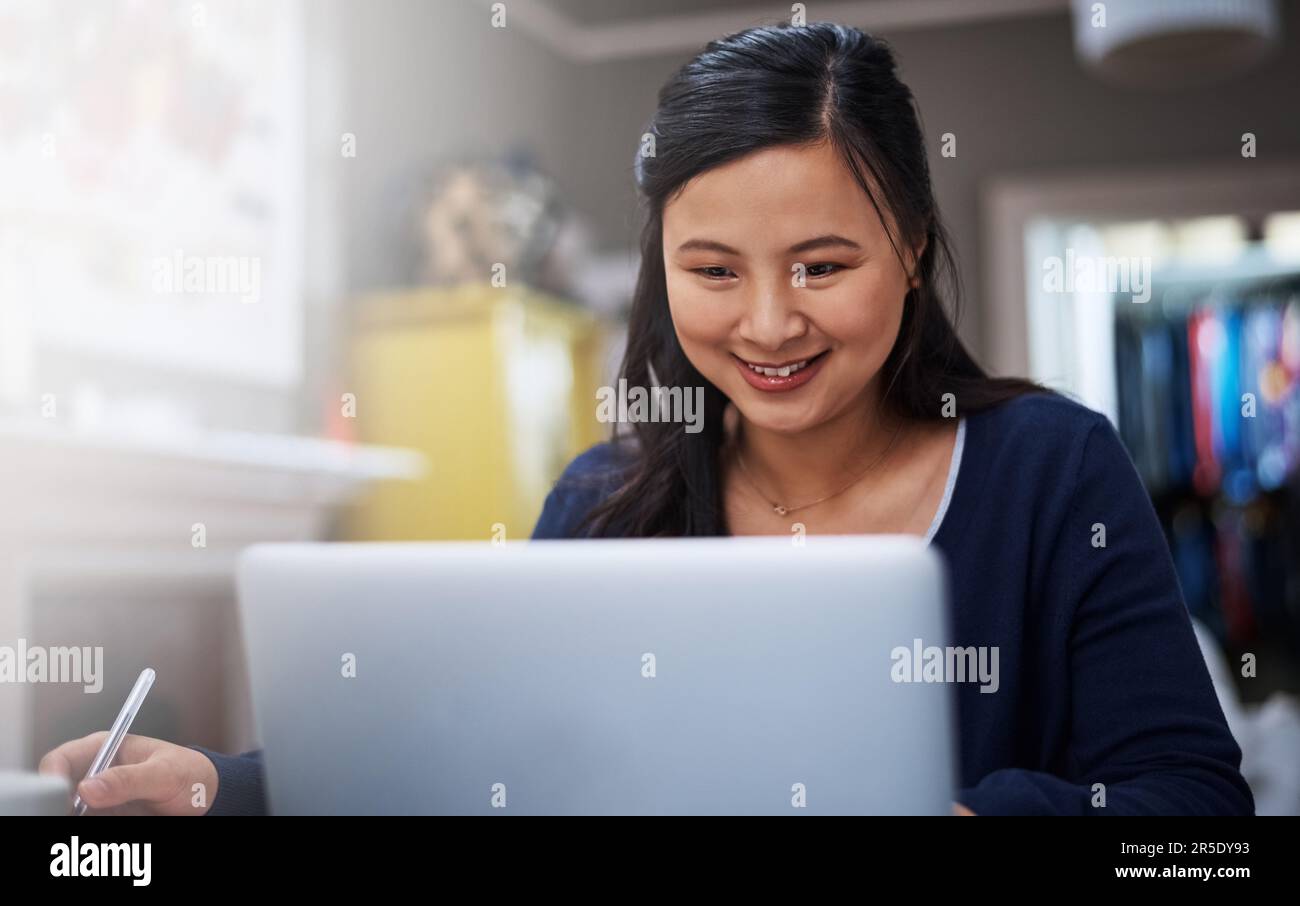 Getting things done from her home office. an attractive young female ...