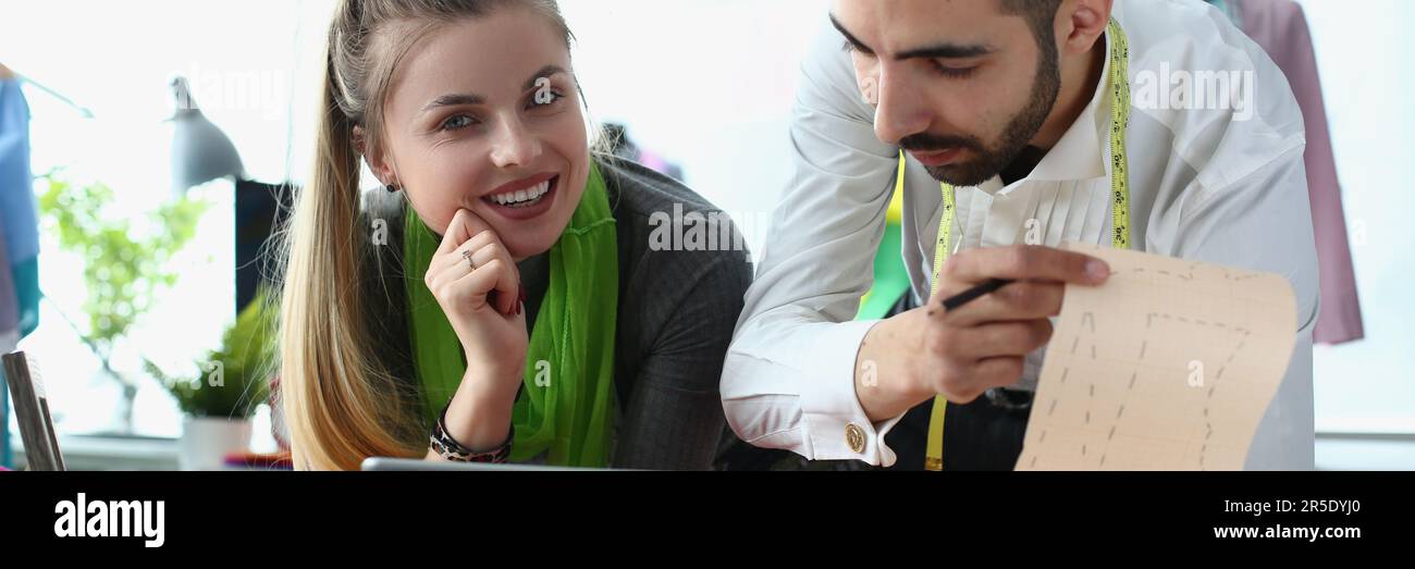 Business woman is using tablet talking to fashion stylist Stock Photo ...