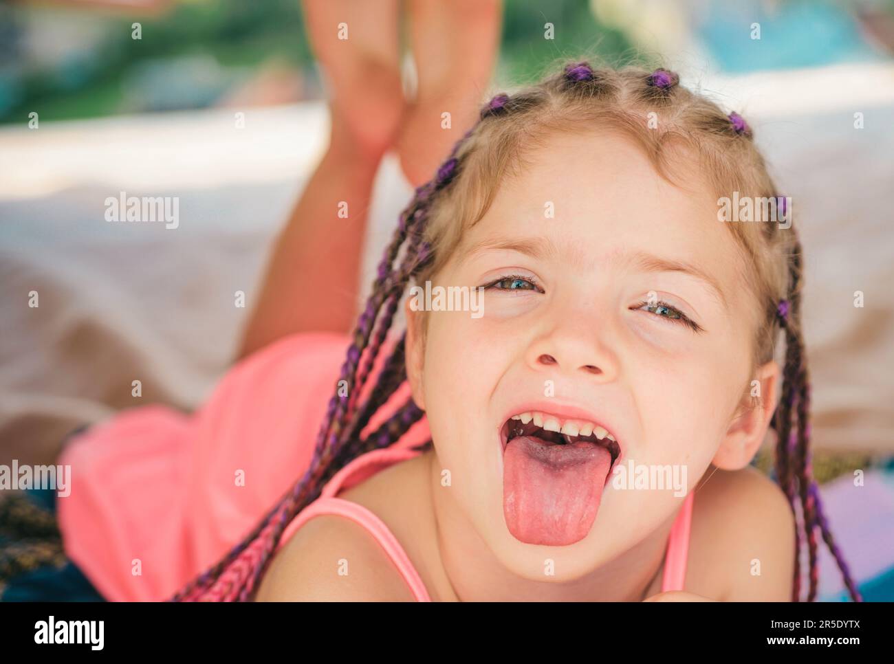 Girl tongue out. Having fun outdoors. Campground. Smiling kid adorable ...