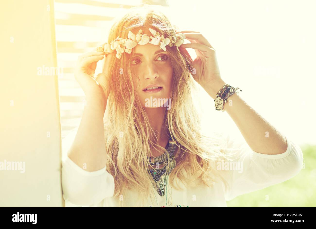 Bohemian beauty. an attractive young woman wearing a head wreath made ...