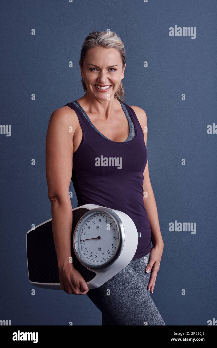 All you need is a goal and a scale. Studio portrait of an attractive ...
