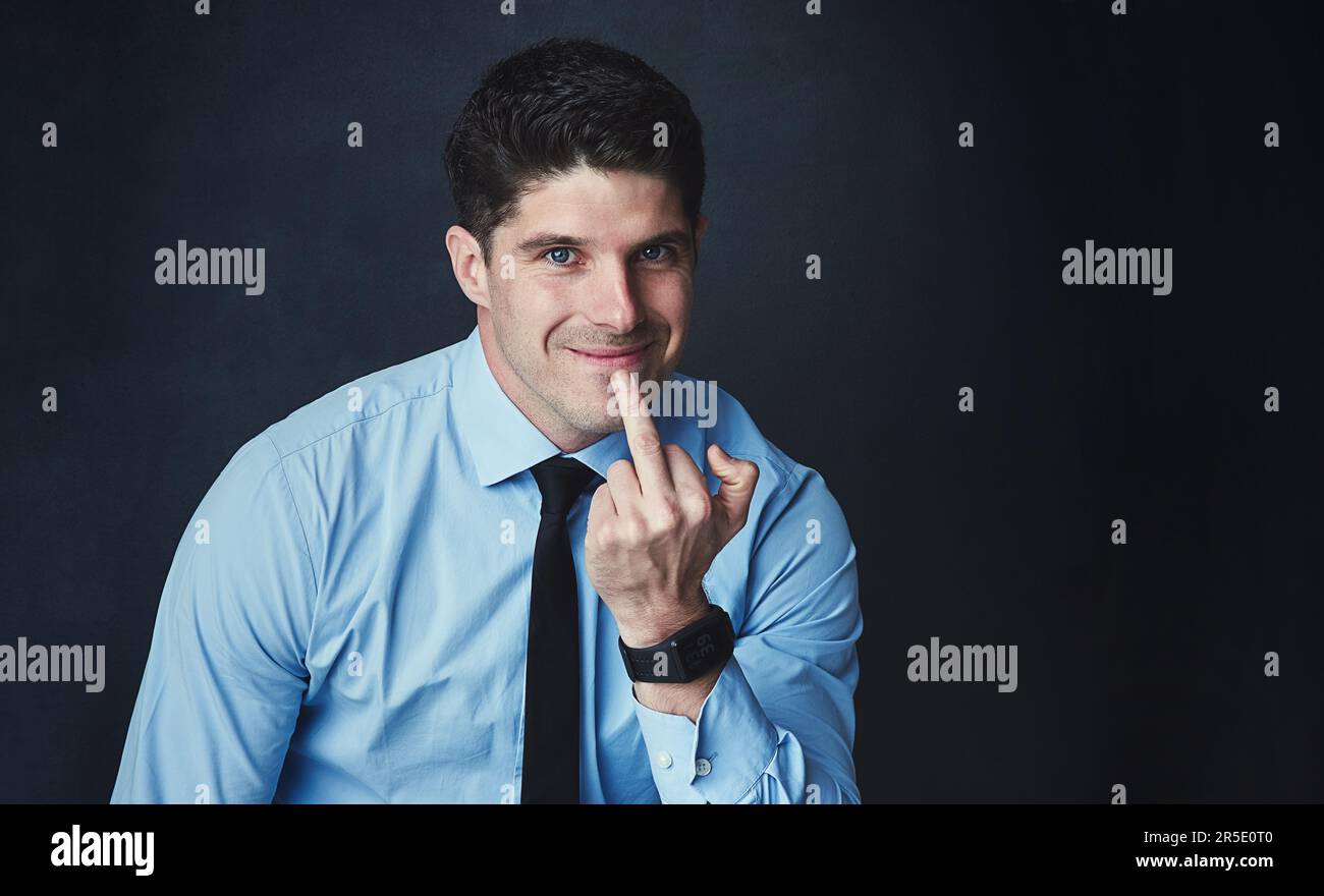 Could you kindly flip off out of my way. Studio portrait of a young ...