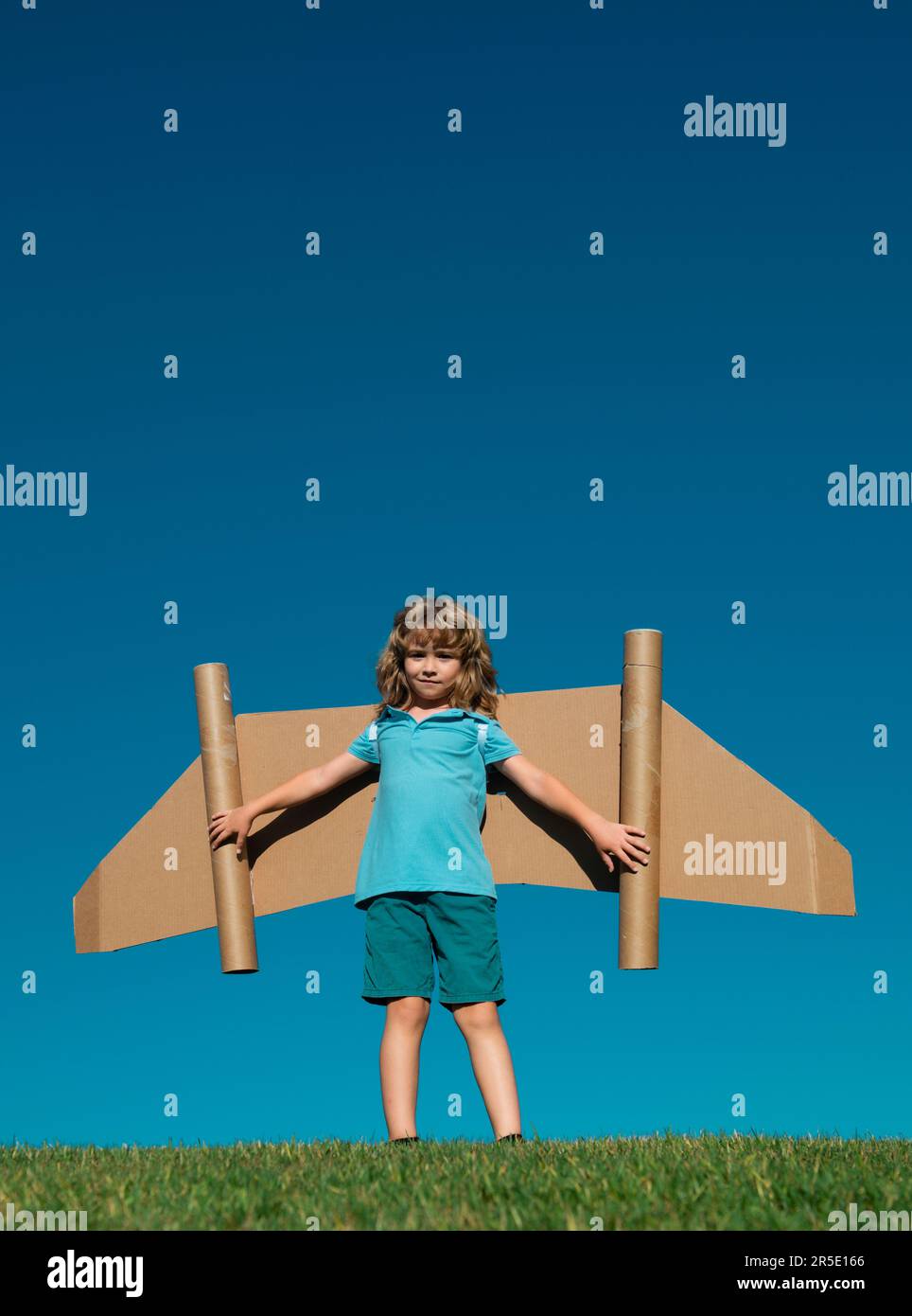 Dreams of travel. Child flying on jetpack with toy airplane on sky ...