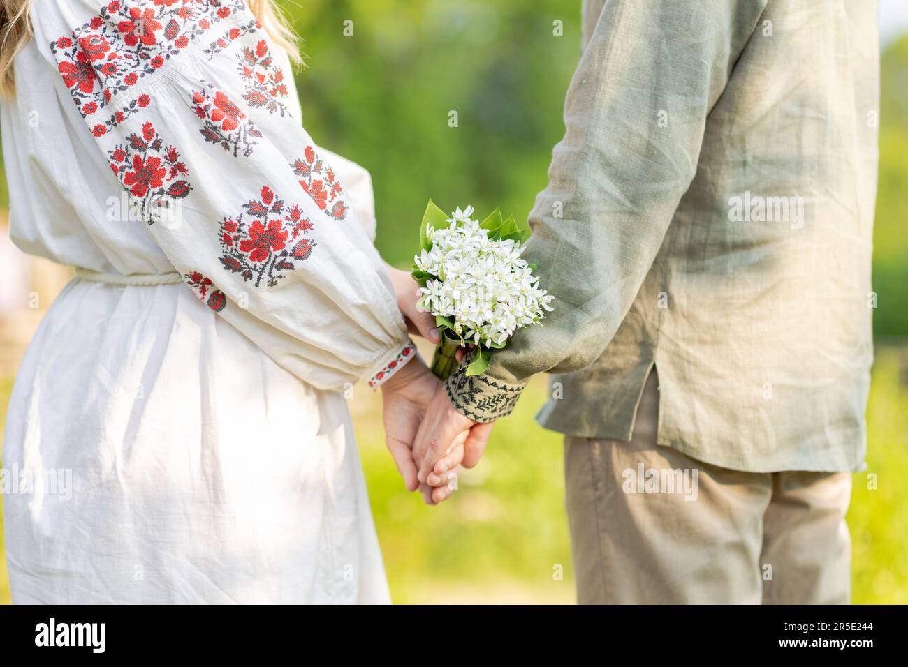 Young ukrainian couple in embroidered national shirts holding hands ...
