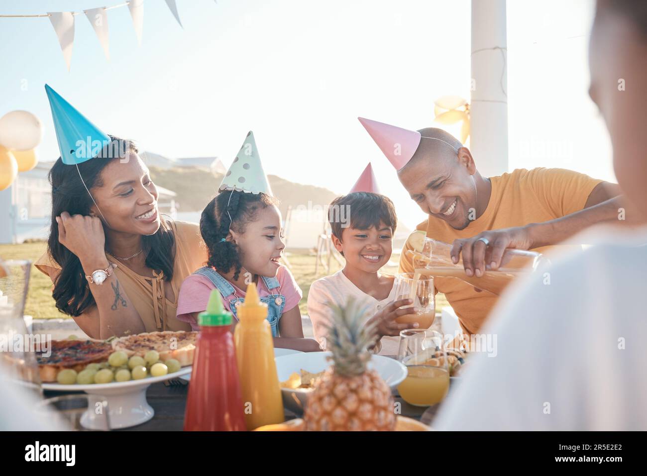 Birthday, parents and kids with food in park for event, celebration and ...