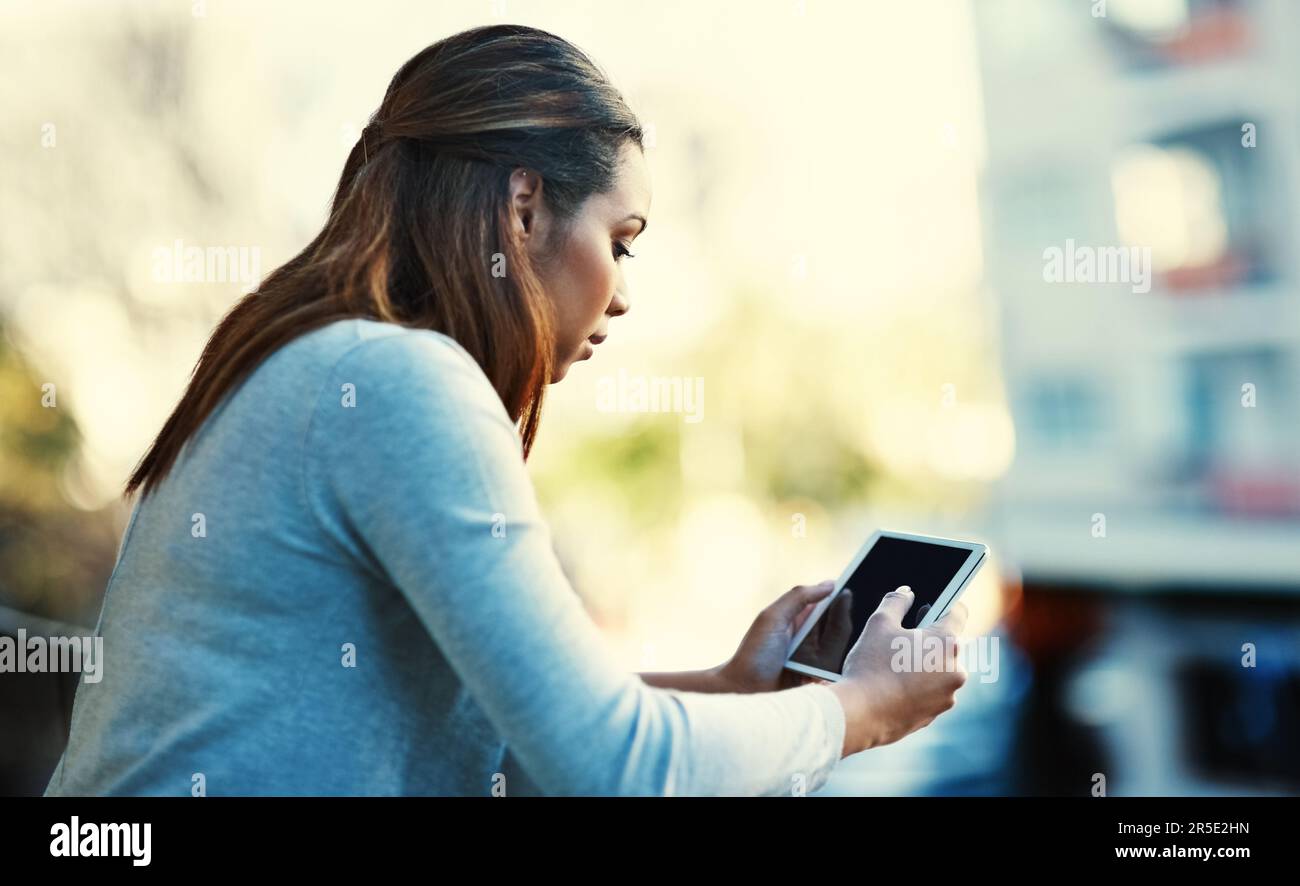 Syncing her skills to technology. a businesswoman using her tablet ...