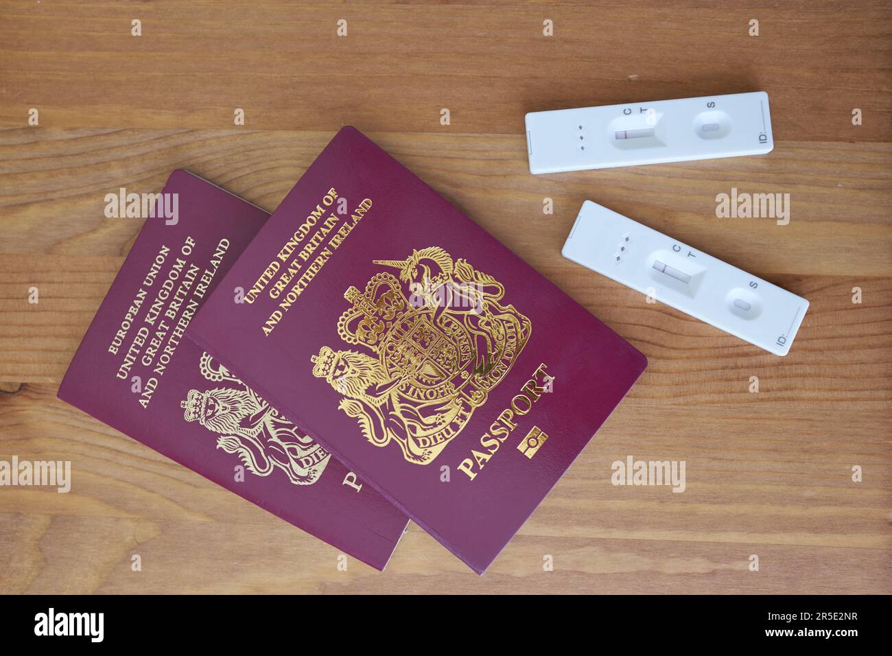 Flat lay view of two British passports with two COVID tests showing ...