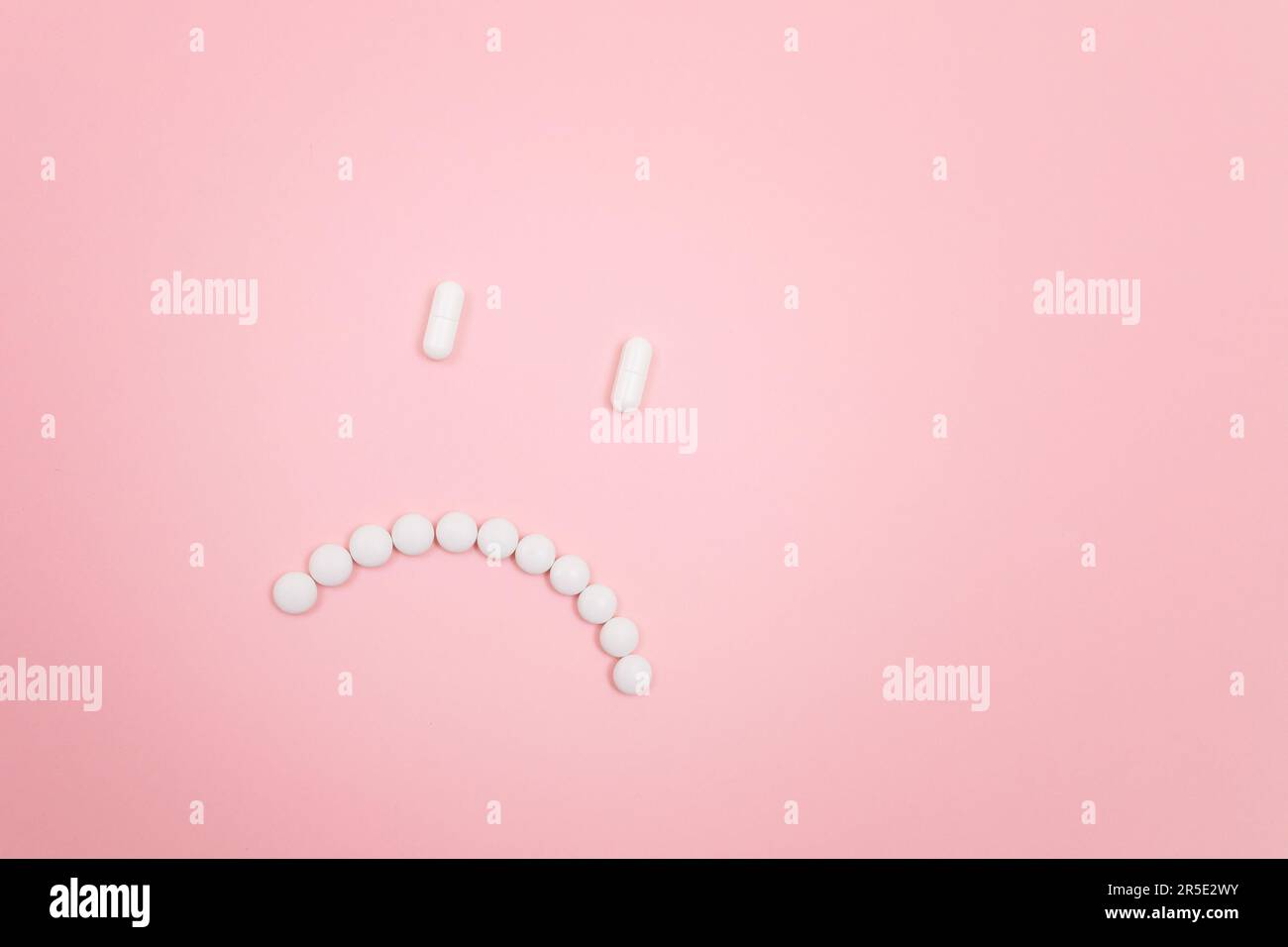 Pharma Harm. Sad Smiley Face Made from White Pills, Lying on Pink ...