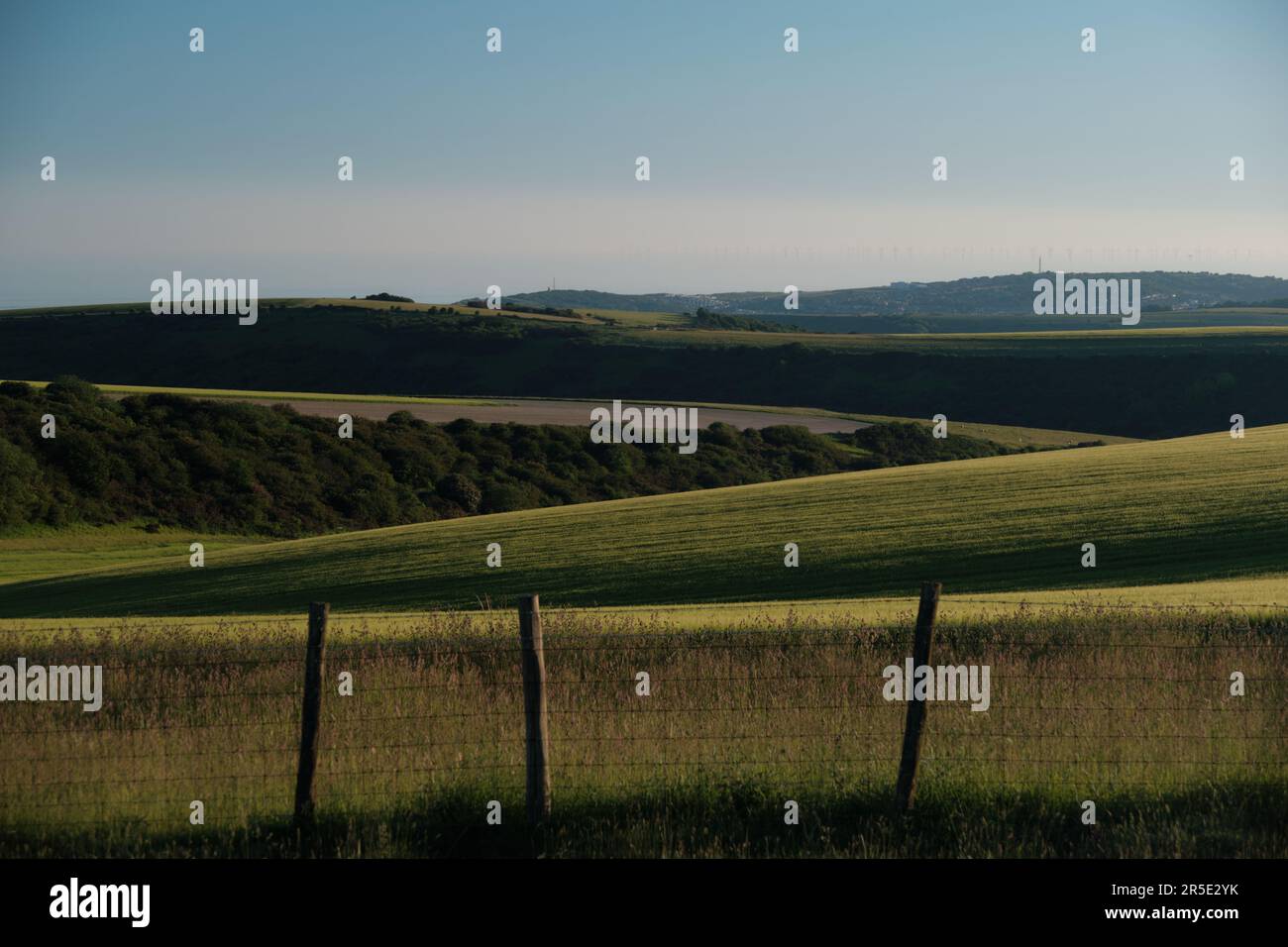 Farmland on a sunny evening in the South Downs National Park with the ...