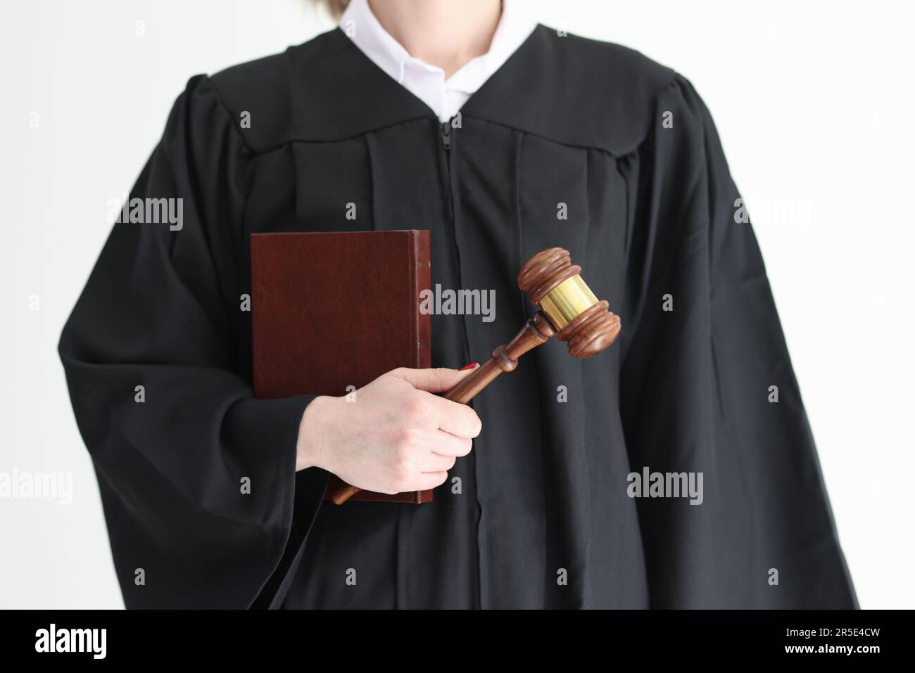 Woman judge in classic gown holds book and wooden mallet Stock Photo ...