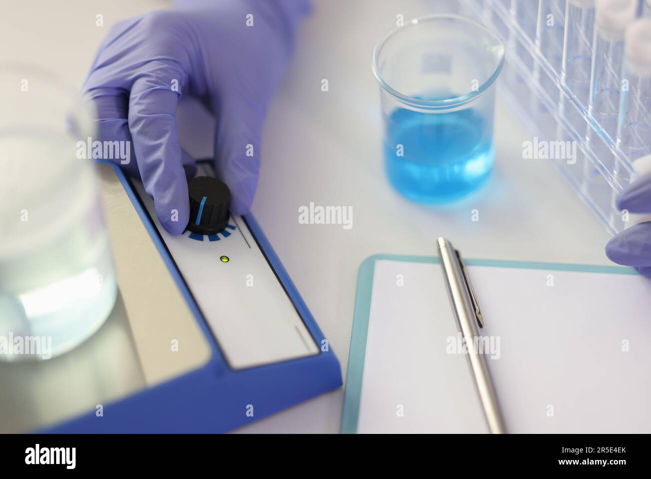 Scientist examines liquids samples in laboratory making note Stock ...