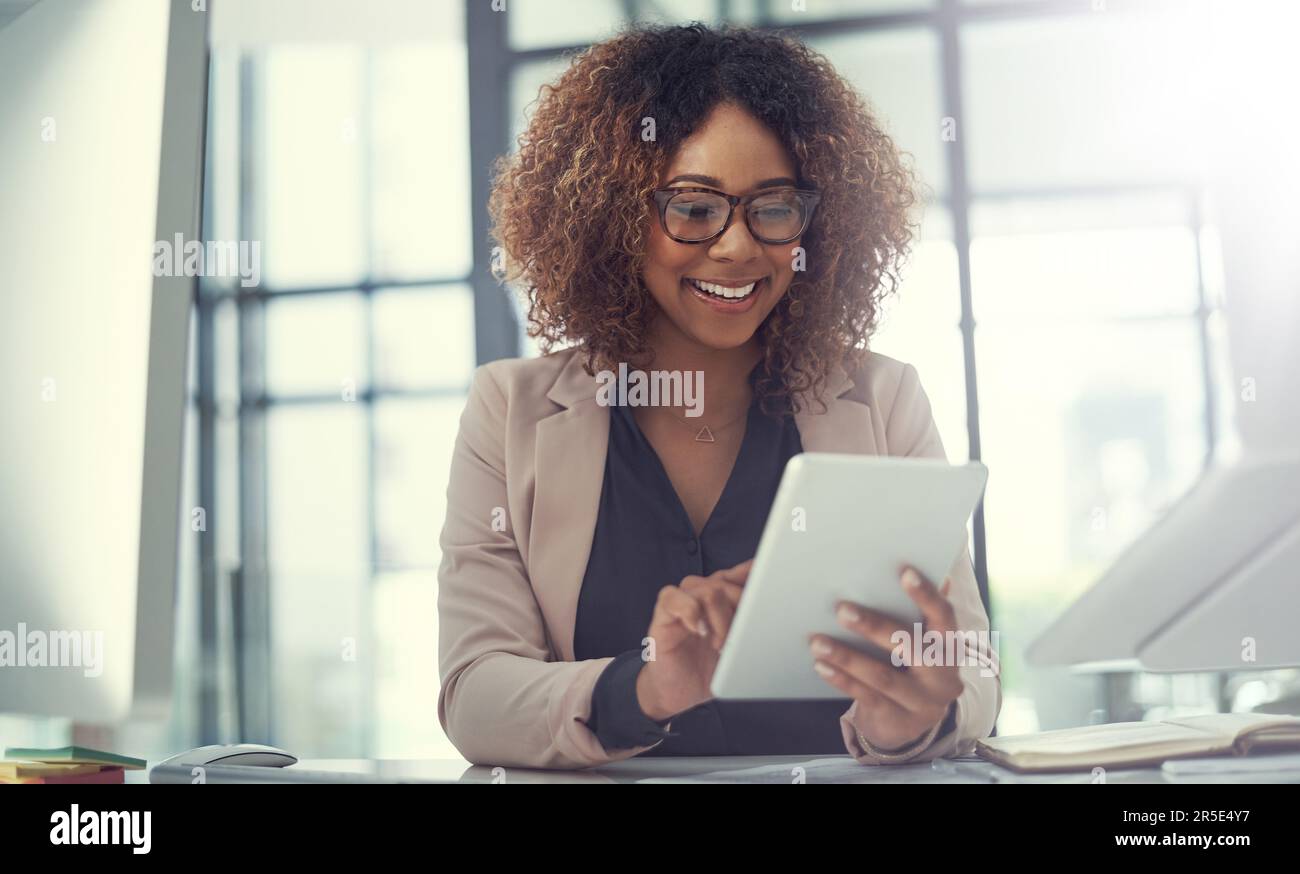 Simplifying business tasks with smart tech. a young businesswoman using ...