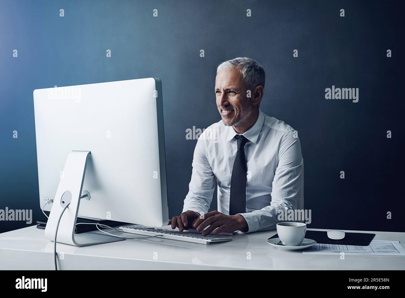 Mature businessman working on computer hi-res stock photography and ...