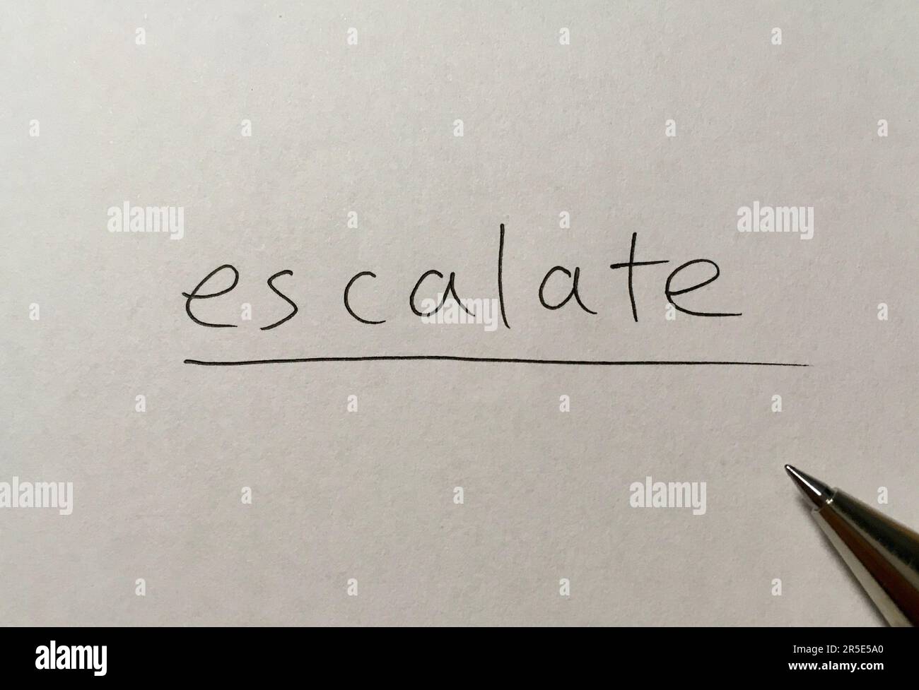 Escalate concept word on paper background Stock Photo - Alamy