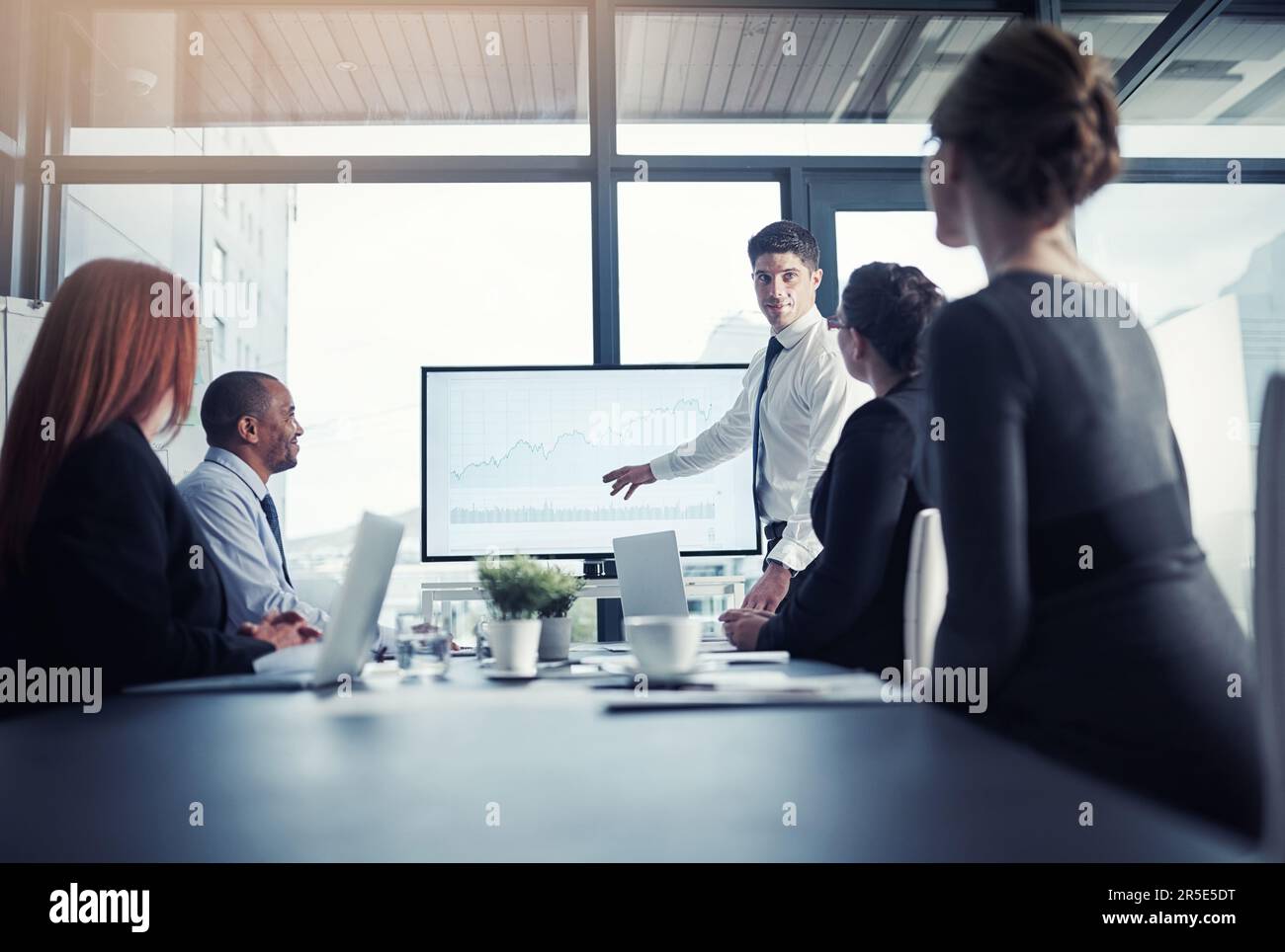 Talking numbers in the boardroom. an executive giving a presentation on ...