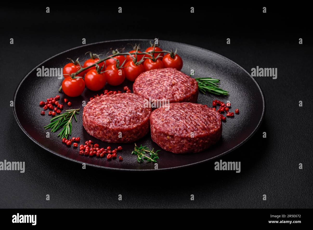 Fresh raw ground beef burger patty with salt and spices on textured ...