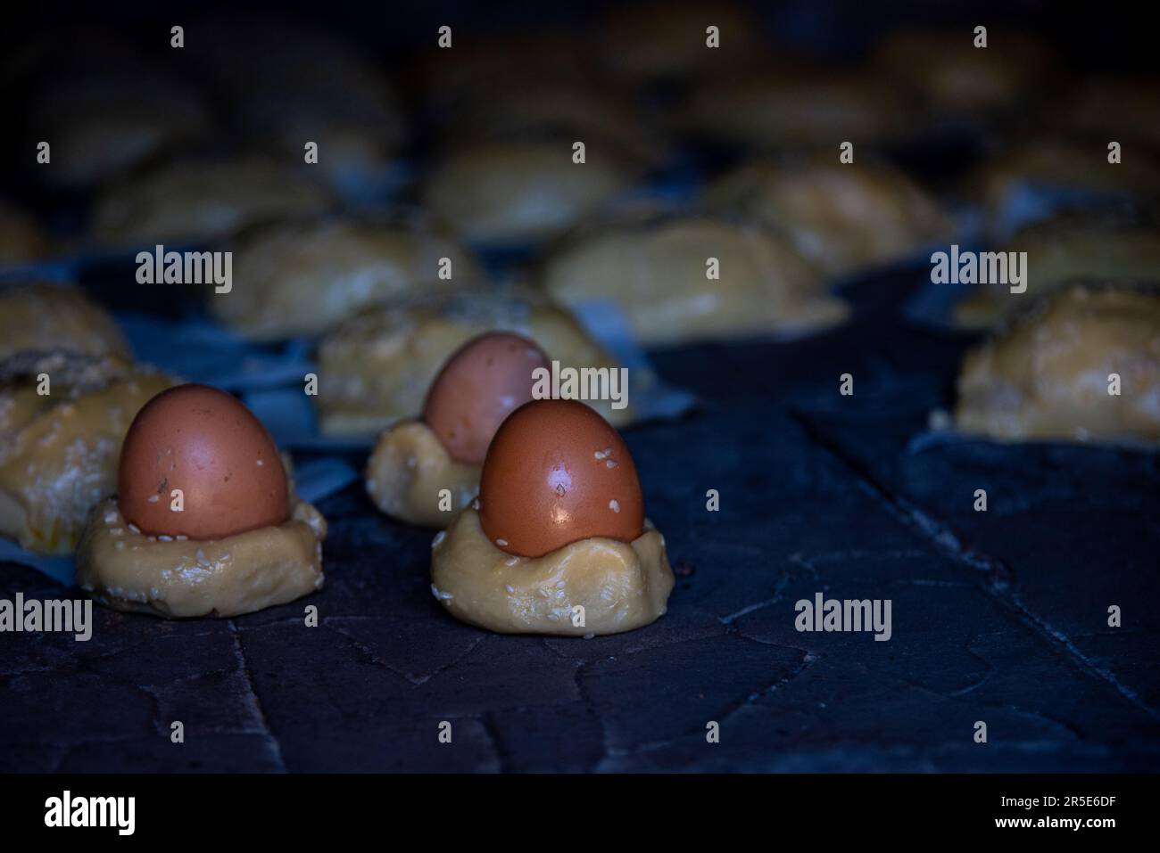 Traditional Cypriot easter cheese pastries flaounes and eggs cooked on ...