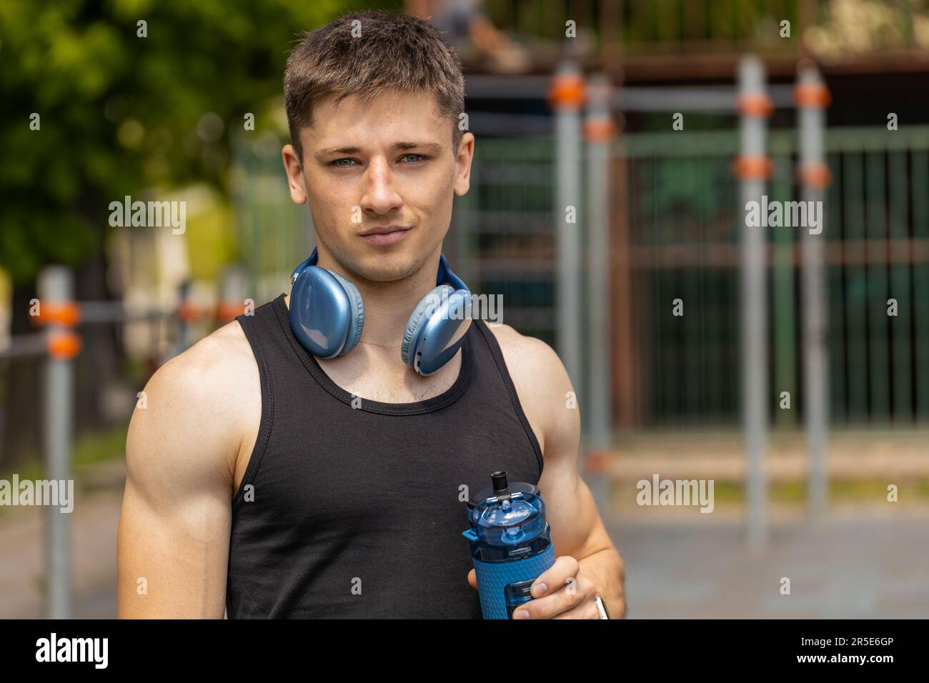 Portrait of athletic caucasian muscular man in sportswear holding ...