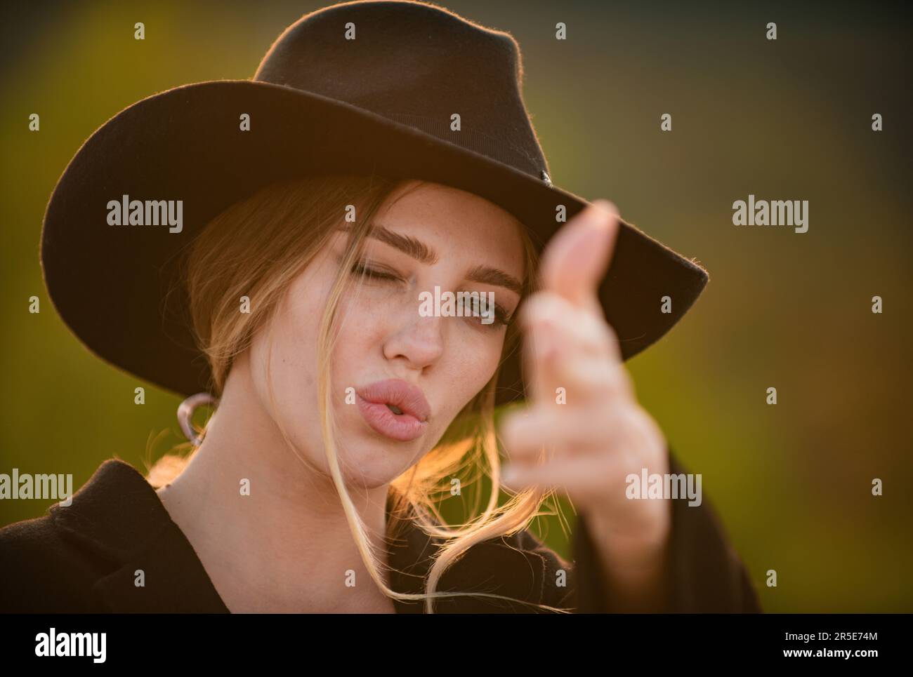 Western woman simulate shooting with and fingers, tender girl. Fashion ...