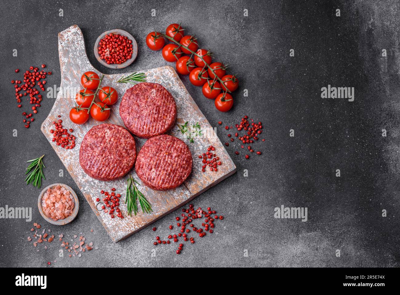 Fresh raw ground beef burger patty with salt and spices on textured ...