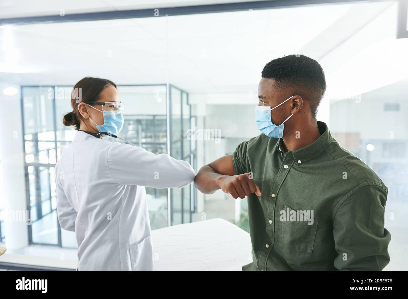 Elbow greetings are the new handshakes. a young doctor and patient ...