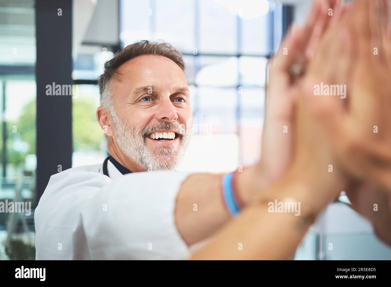 My team will do me proud. a mature doctor giving his colleagues a high ...