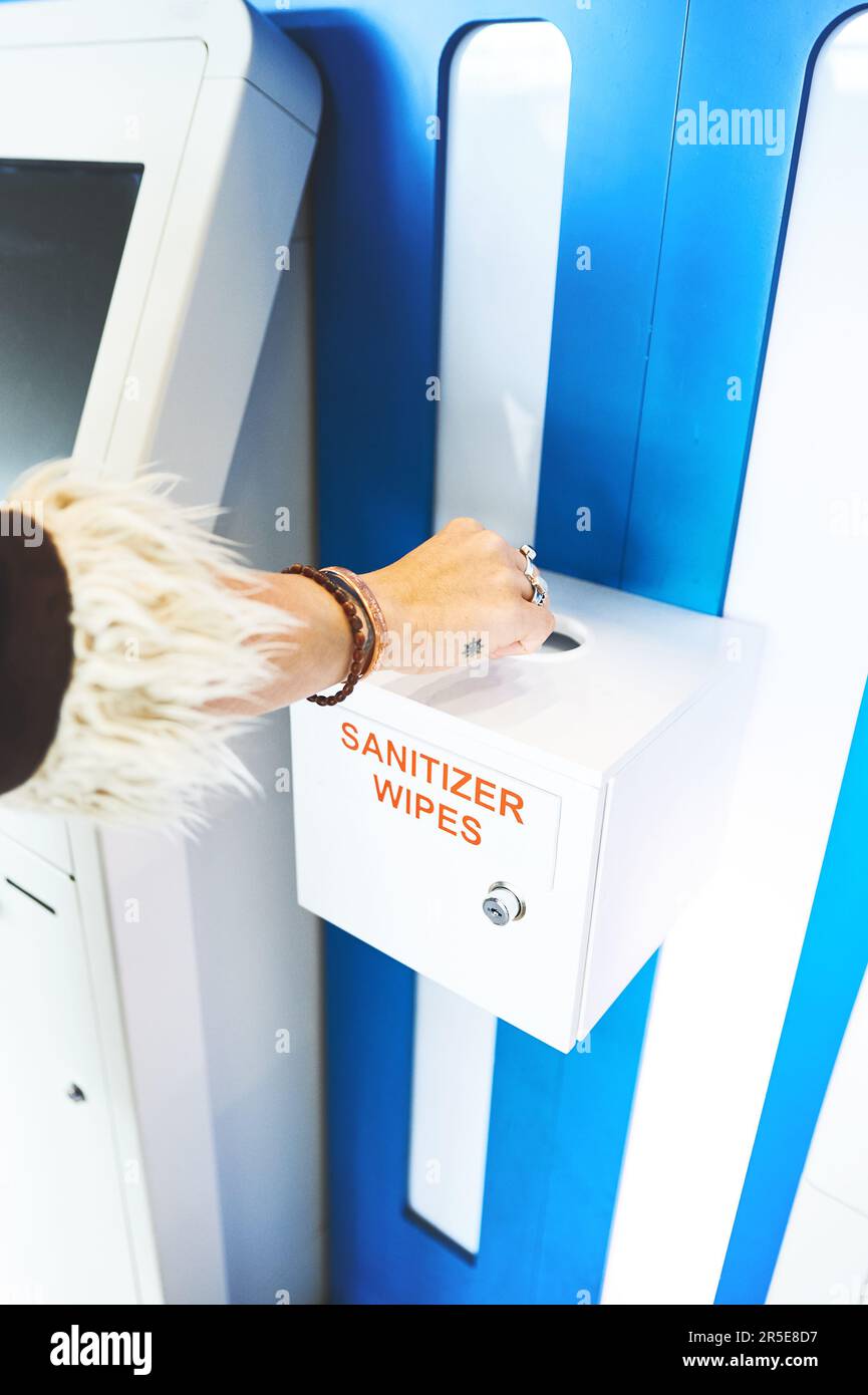 Safety first. a person using the sanitiser wipes at the airport Stock ...