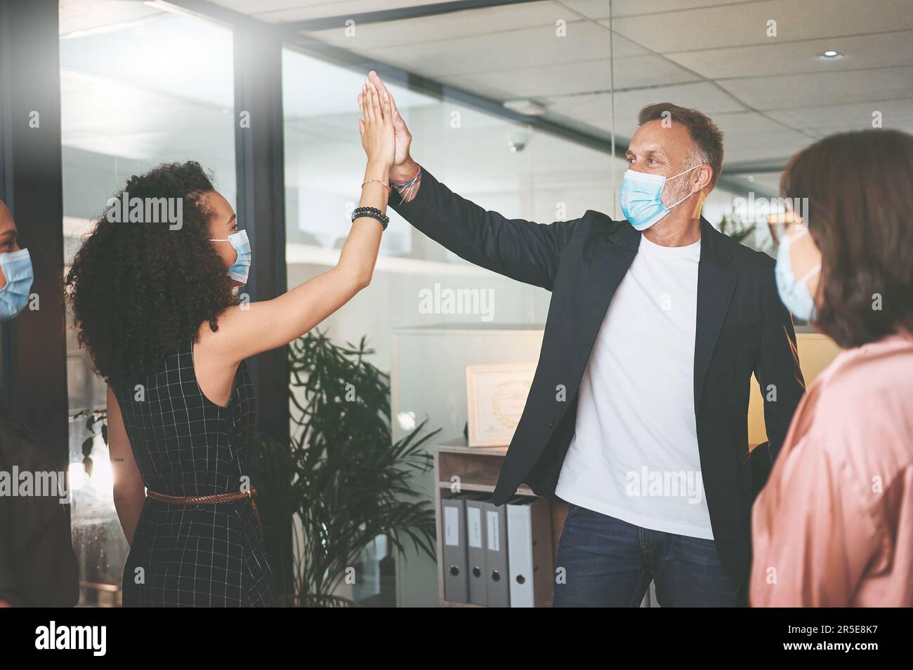 Success, here we come. two businesspeople standing together and giving ...