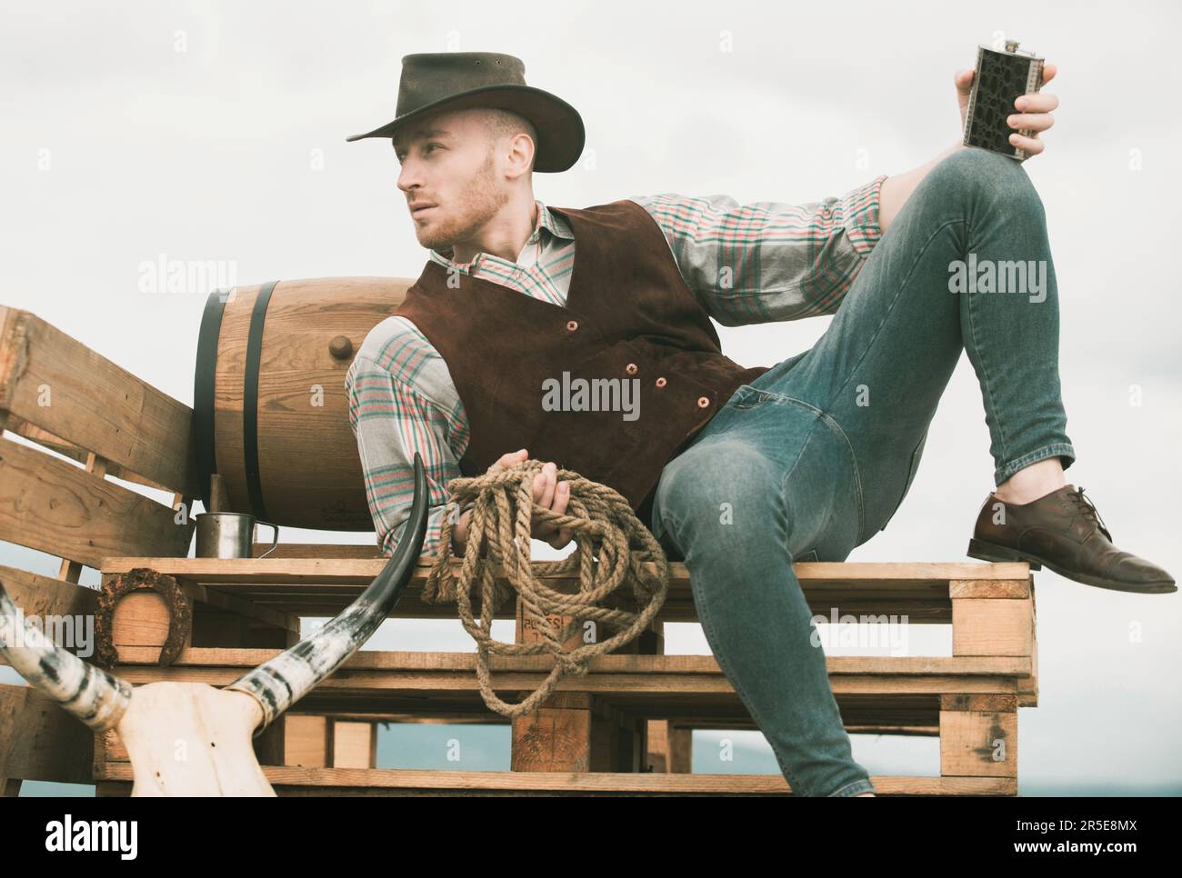 Cowboy on ranch. Handsome man in cowboy hat and retro vintage outfit ...