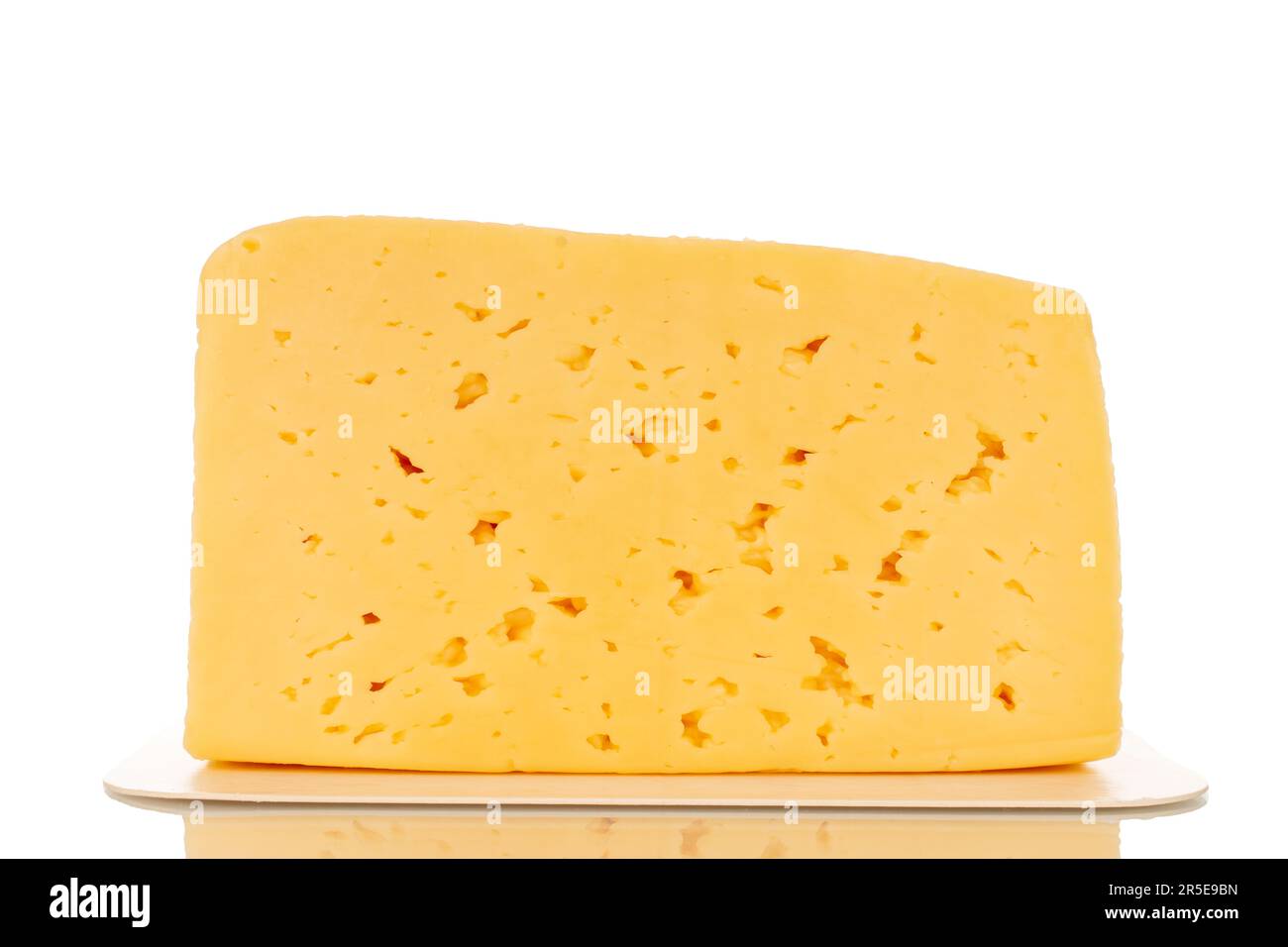 One piece of cheese on a white paper plate, macro, isolated on white ...