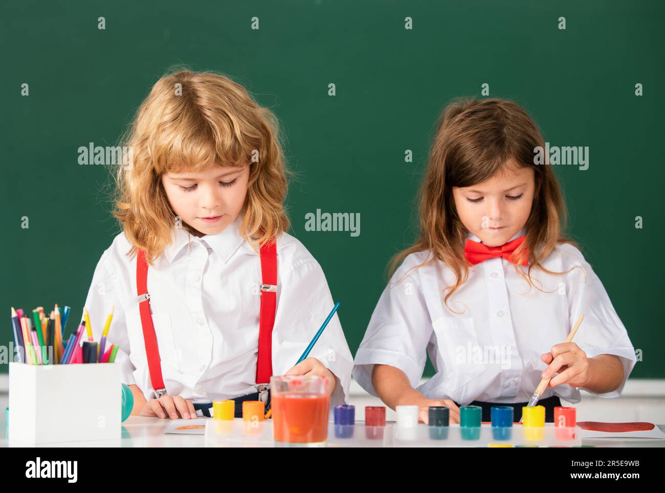 Kids pupils learning painting. Portrait school kids doing art homework ...