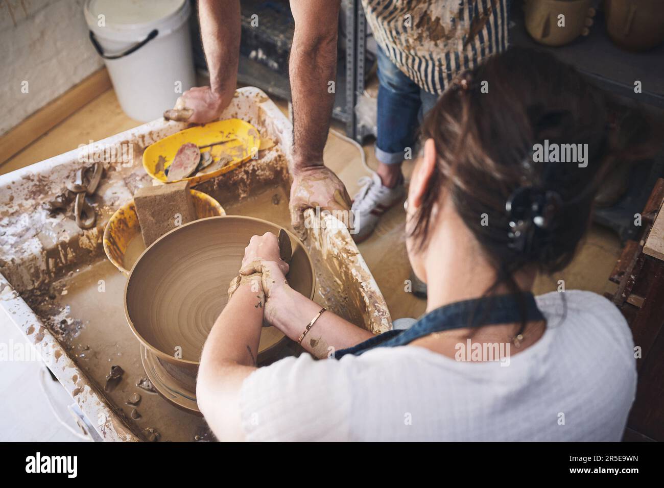 Working with clay comes with many rewards. an unrecognisable woman working with clay in a ...