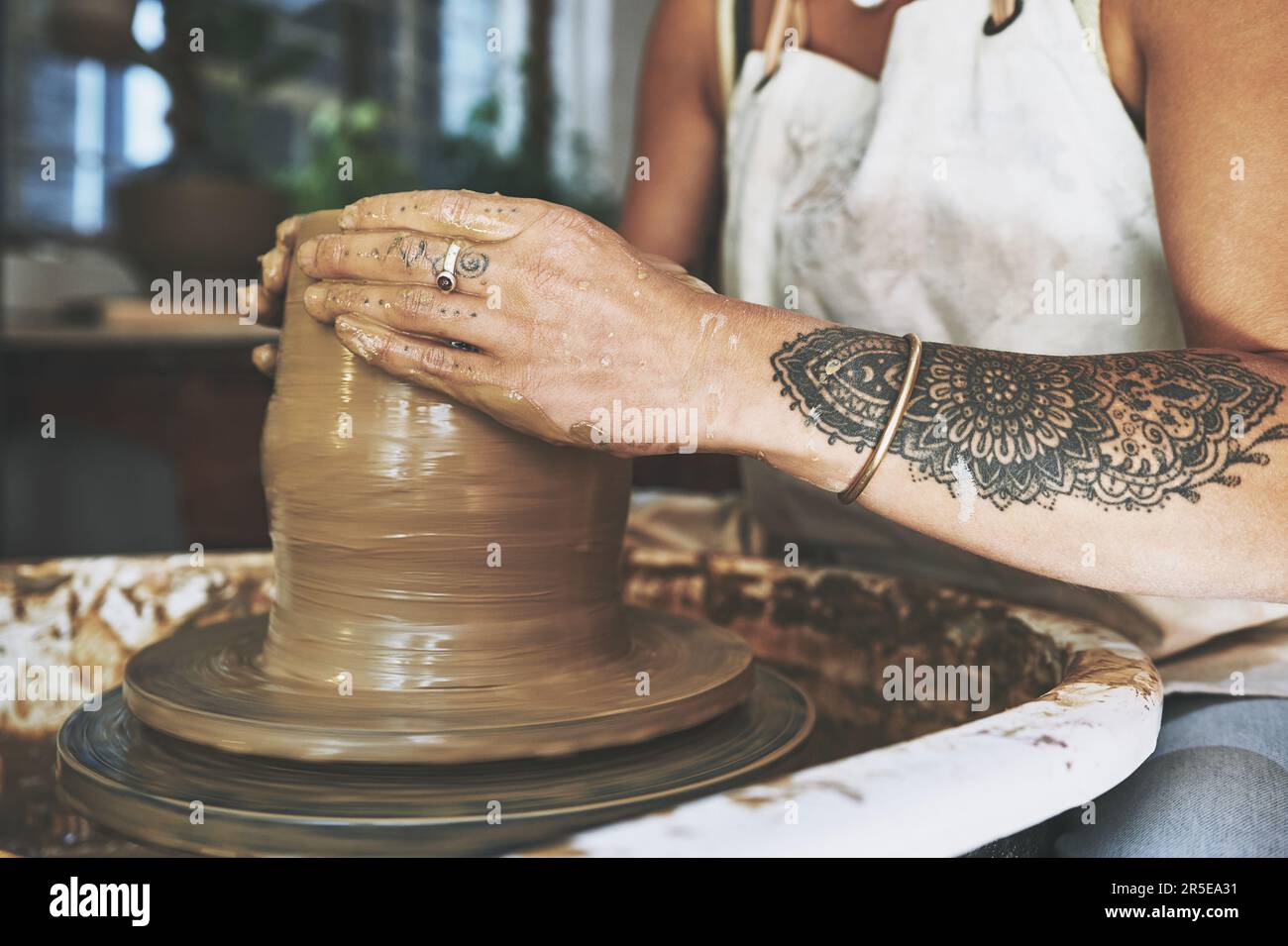 Break open the clay, its time to play. an unrecognisable woman working ...