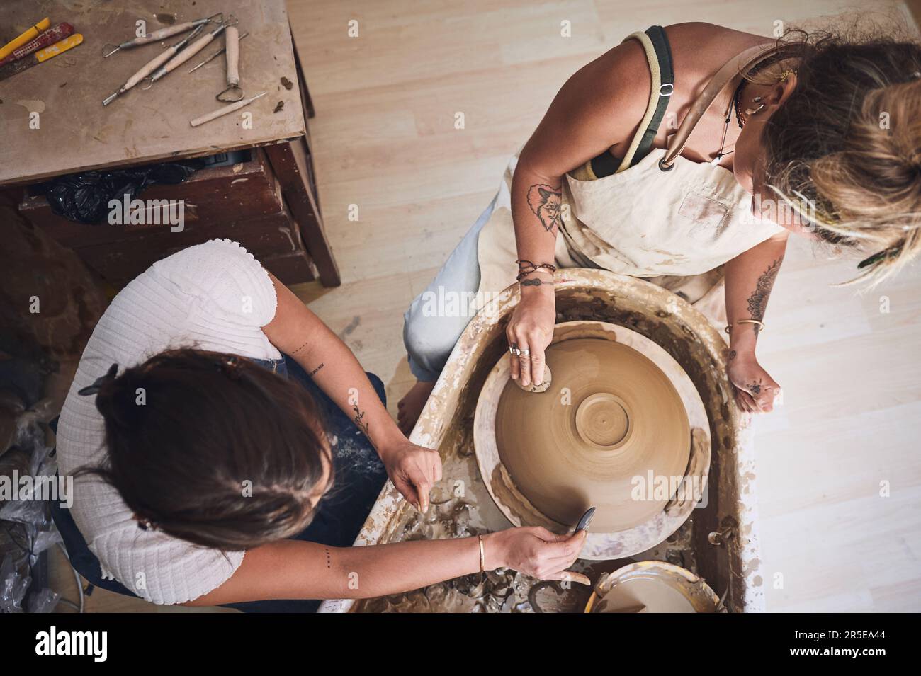 It was just mud until they came along. two young women working with ...