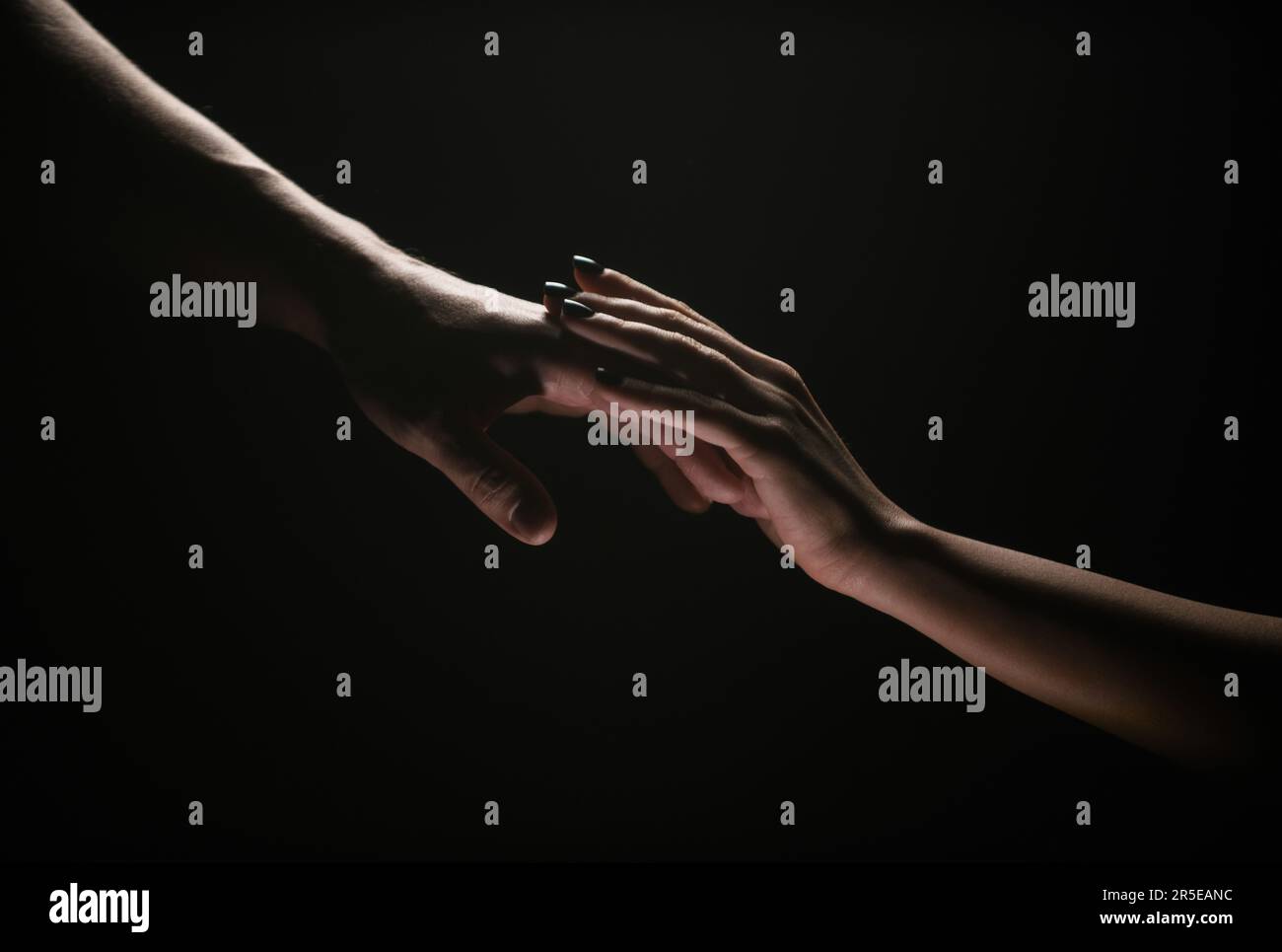 Two hands at the moment of farewell. The holding hands of relations ...