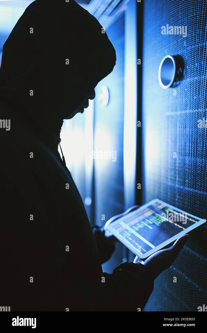 Stealing is always so thrilling. a hacker using a digital tablet in a ...