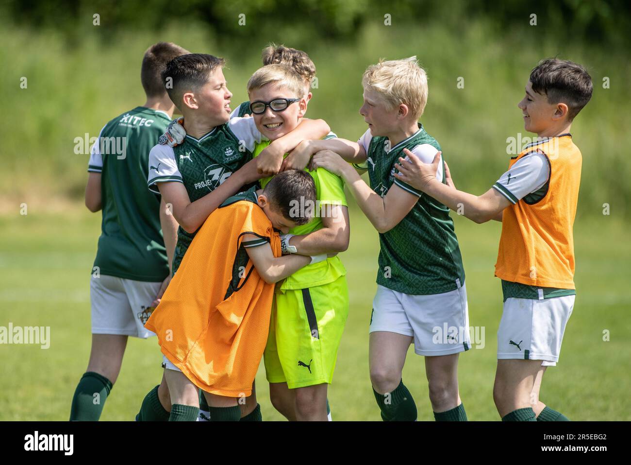 Boy wearing glasses whilst playing football hi-res stock photography ...
