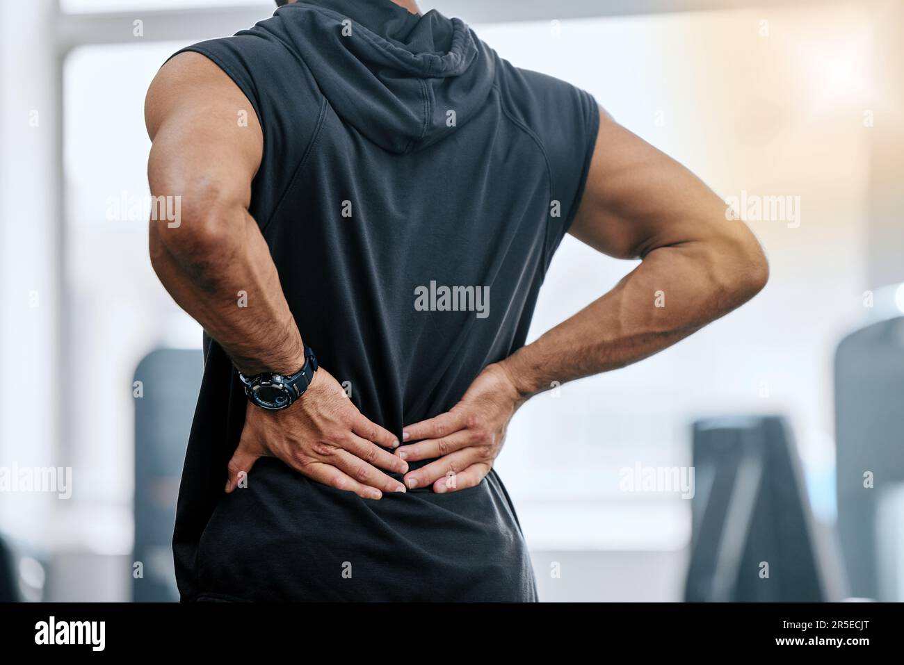 Gym, injury and man with hand on back pain for medical emergency from ...