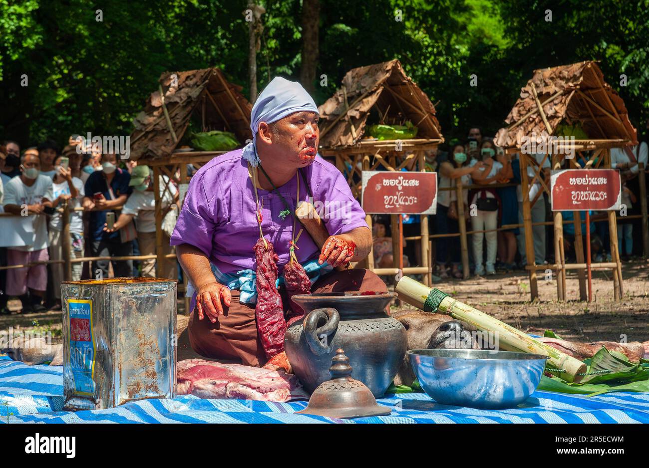 A Thai man involves ' medium ' looks on during the Pu Sae Ya Sae ...