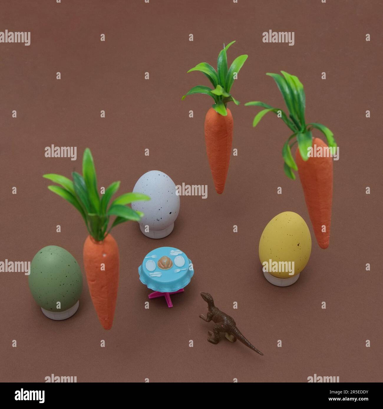 Easter eggs of different colors with carrots in the air and a set table ...