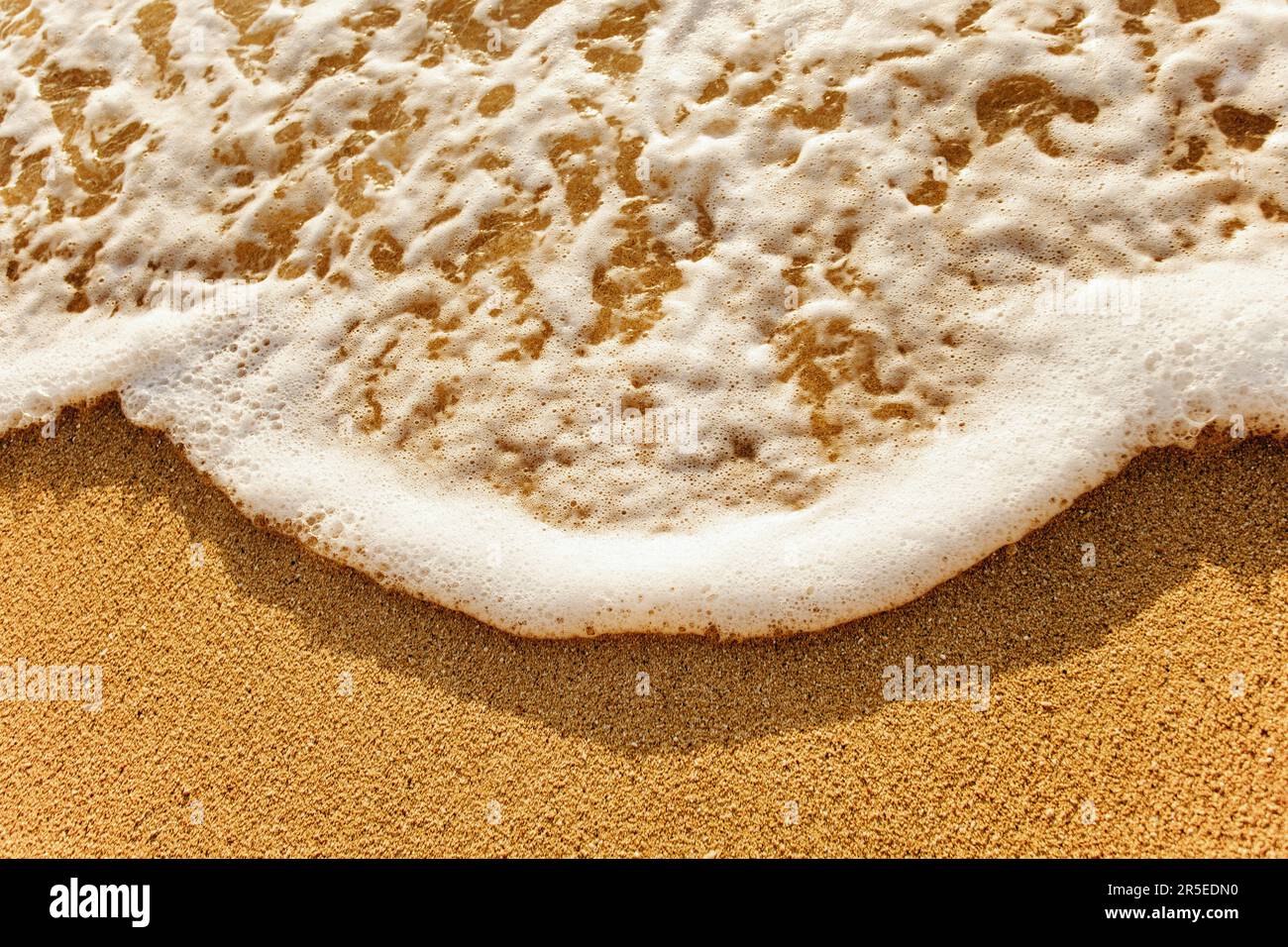 Foam of the ocean on the beach Stock Photo - Alamy