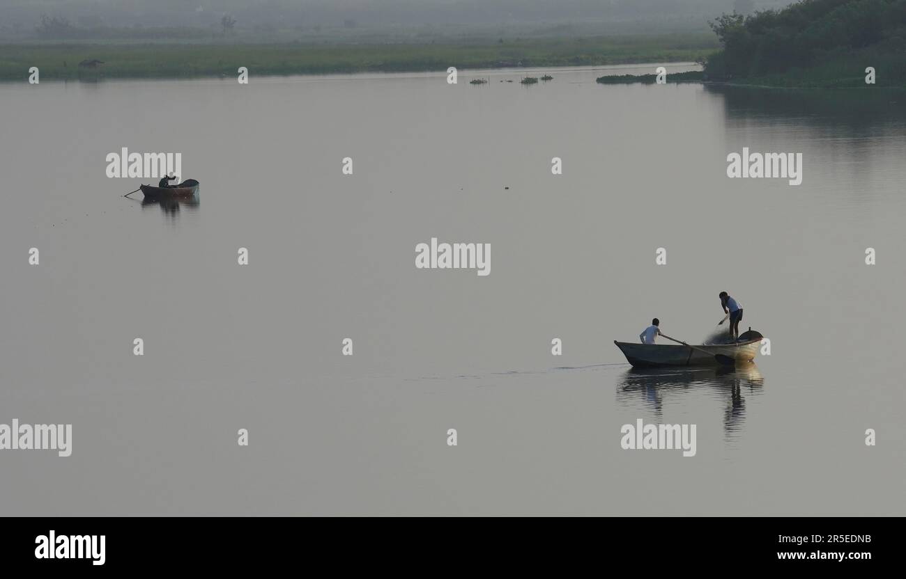 Fishermen return with their catch in the River Ganges in Kanpur, India ...